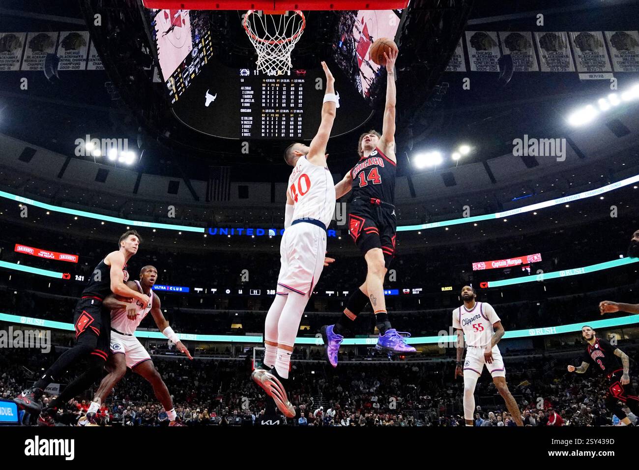 Chicago Bulls forward Matas Buzelis, right, drives to the basket ...