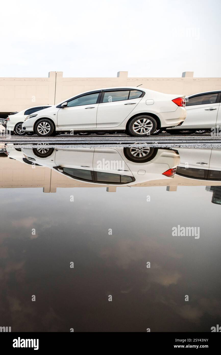 The landscape of cars parked in parking areas, and reflected on the ...