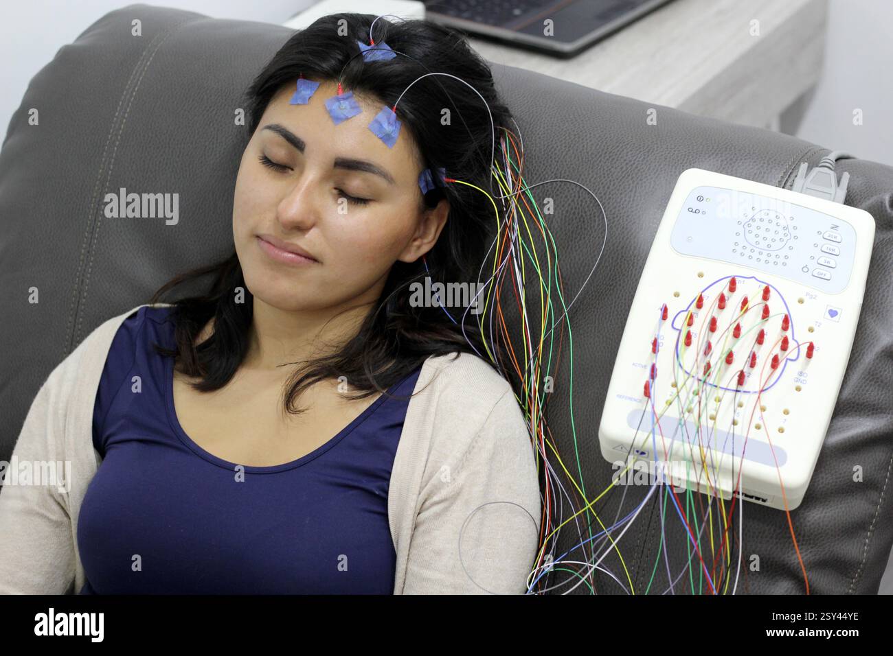 20-year-old Latina woman undergoes a neurological study Electroencephalogram EEG with cables in ...
