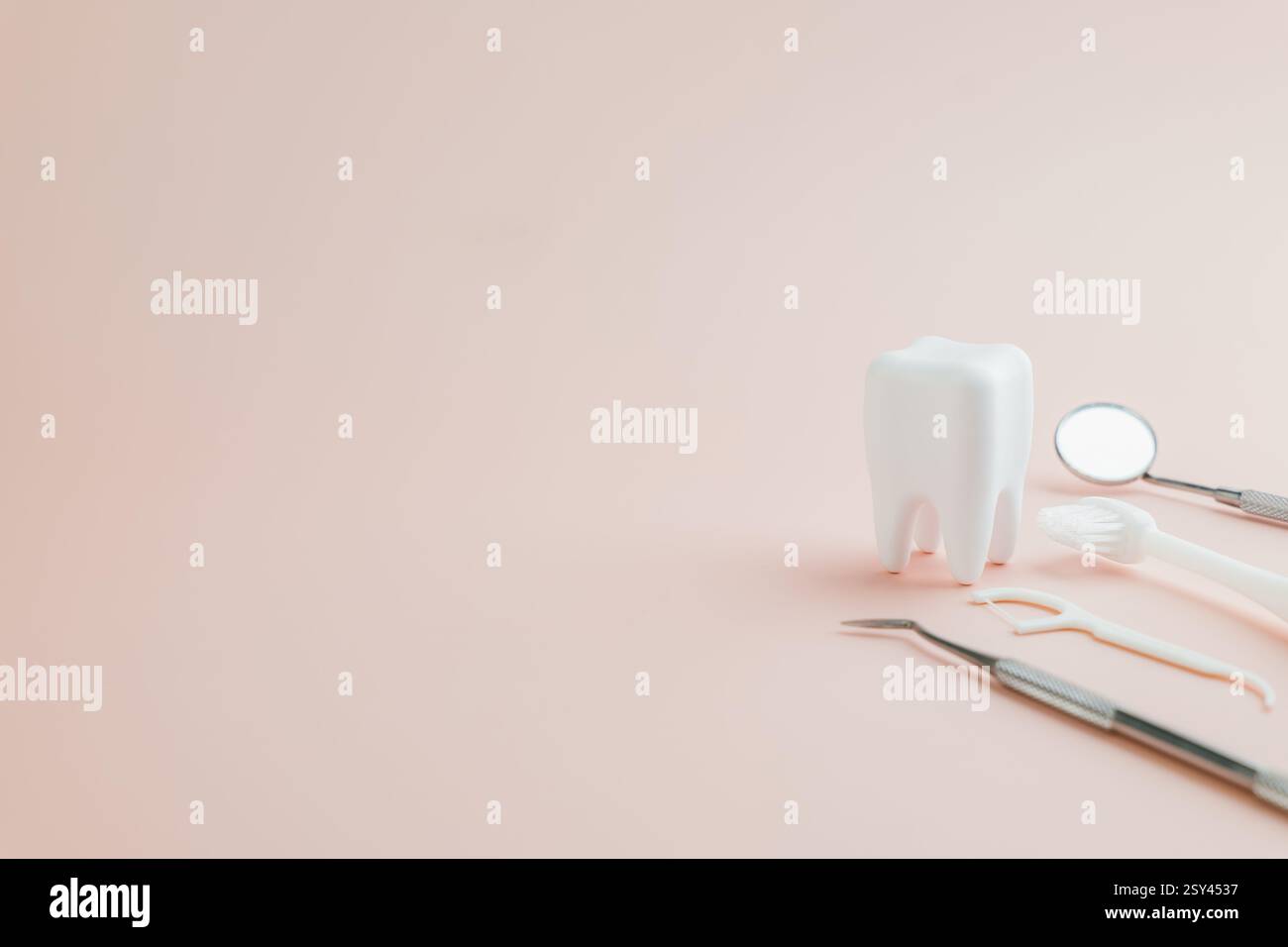Celebrate Dentist Day with a teeth model and dentist tools on a pink ...