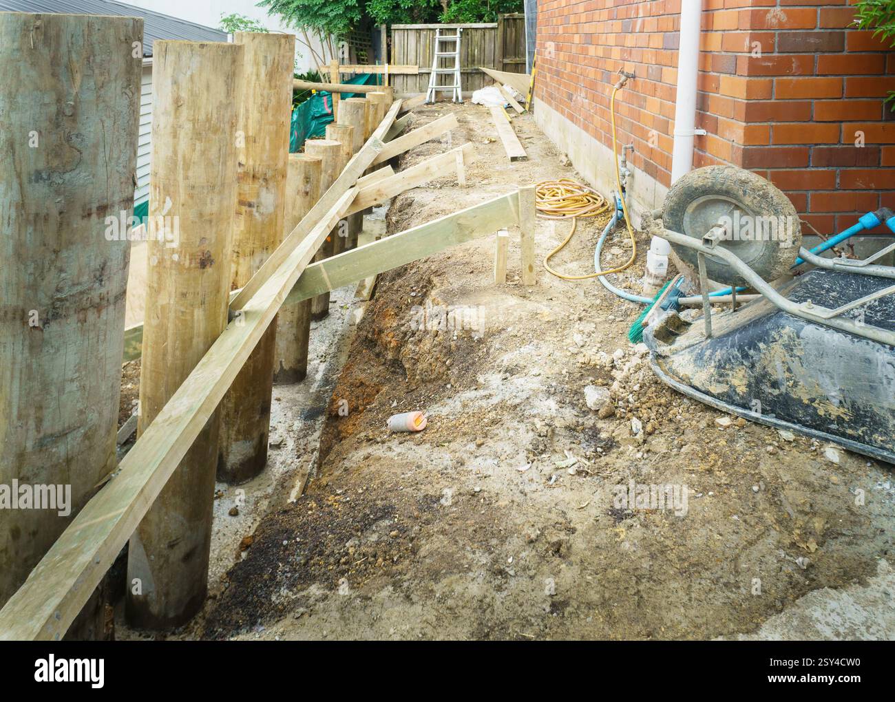 Retaining wall posts set in concrete. Construction site for retaining ...