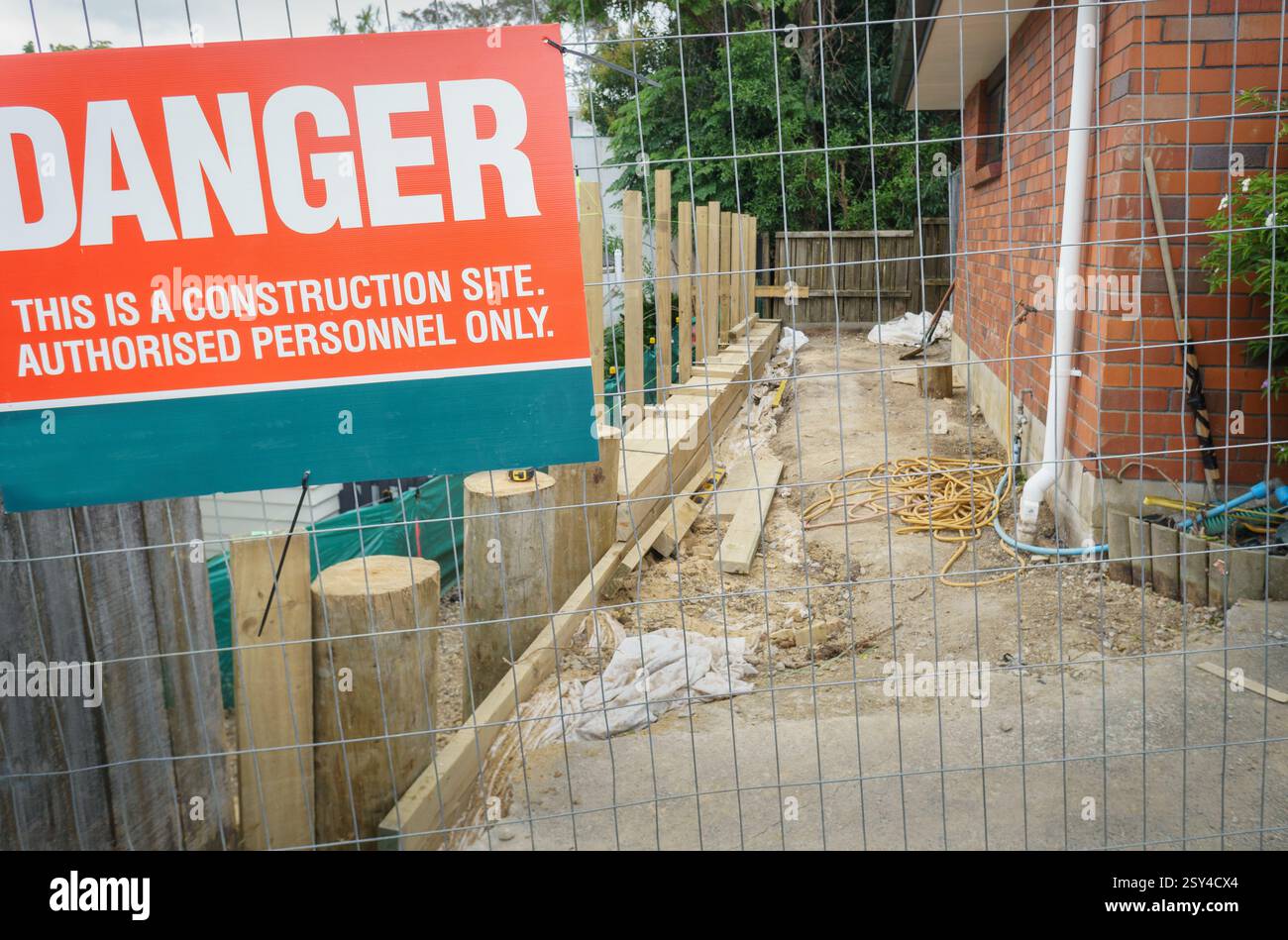 Danger sign on metal protection fence. Construction site for ...