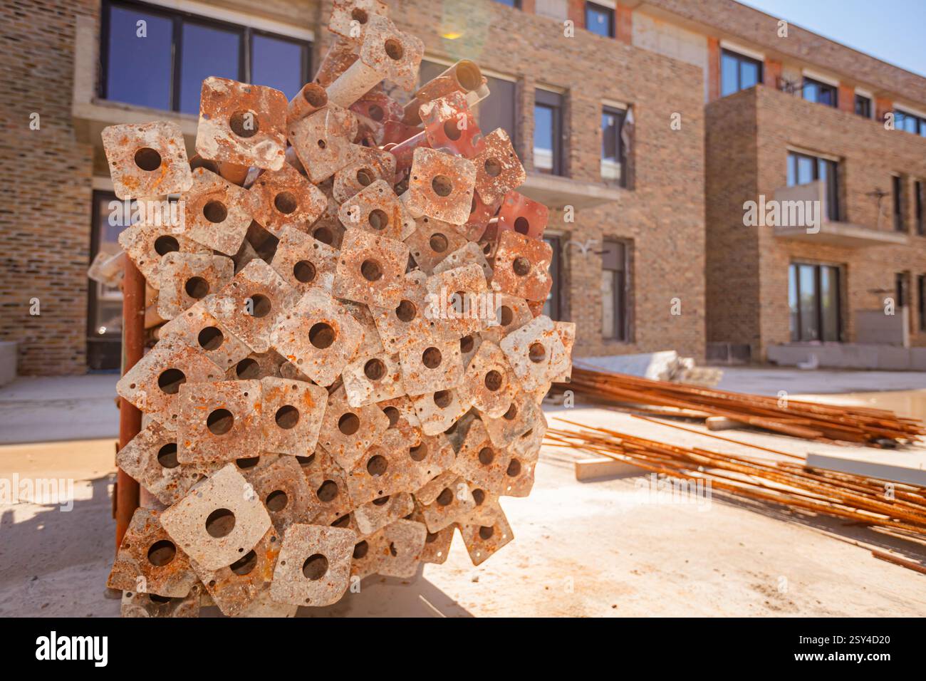 Stack of metal rusty pipes in improvised pallet, carrier, for transport ...