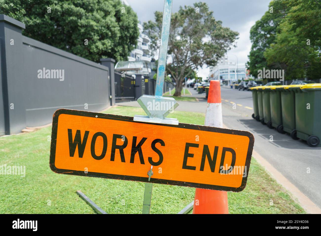 “Works End” road sign and orange traffic cones on the roadside ...