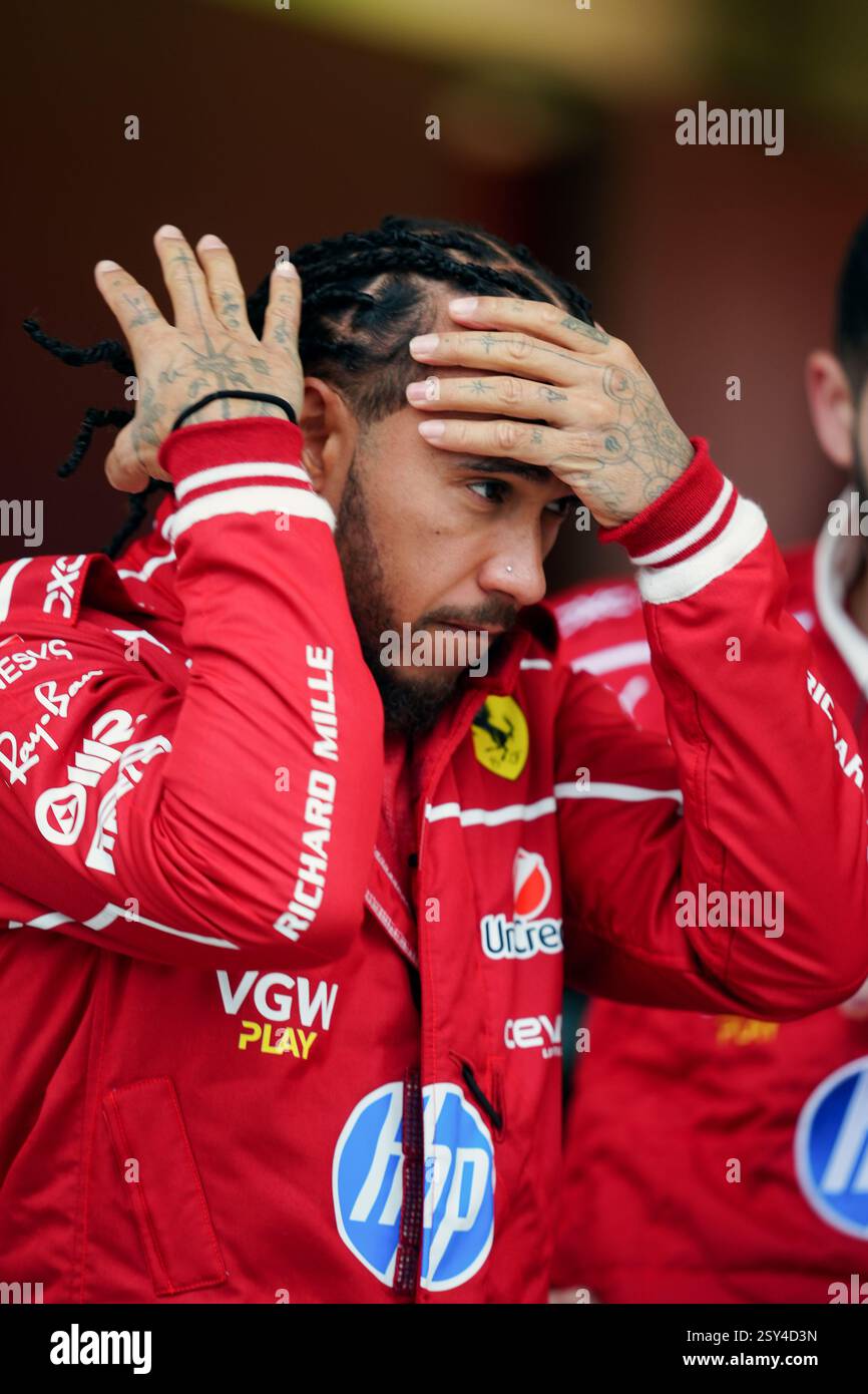 Ferrari driver Lewis Hamilton ties back his hair on day two of pre ...