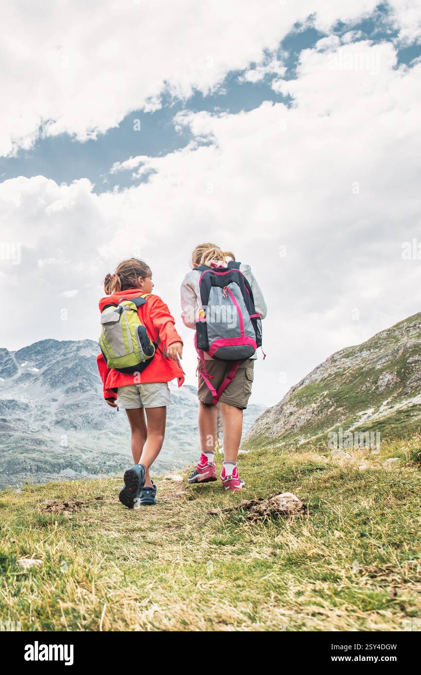 Two girls during mountain walking in the Alps Stock Photo - Alamy