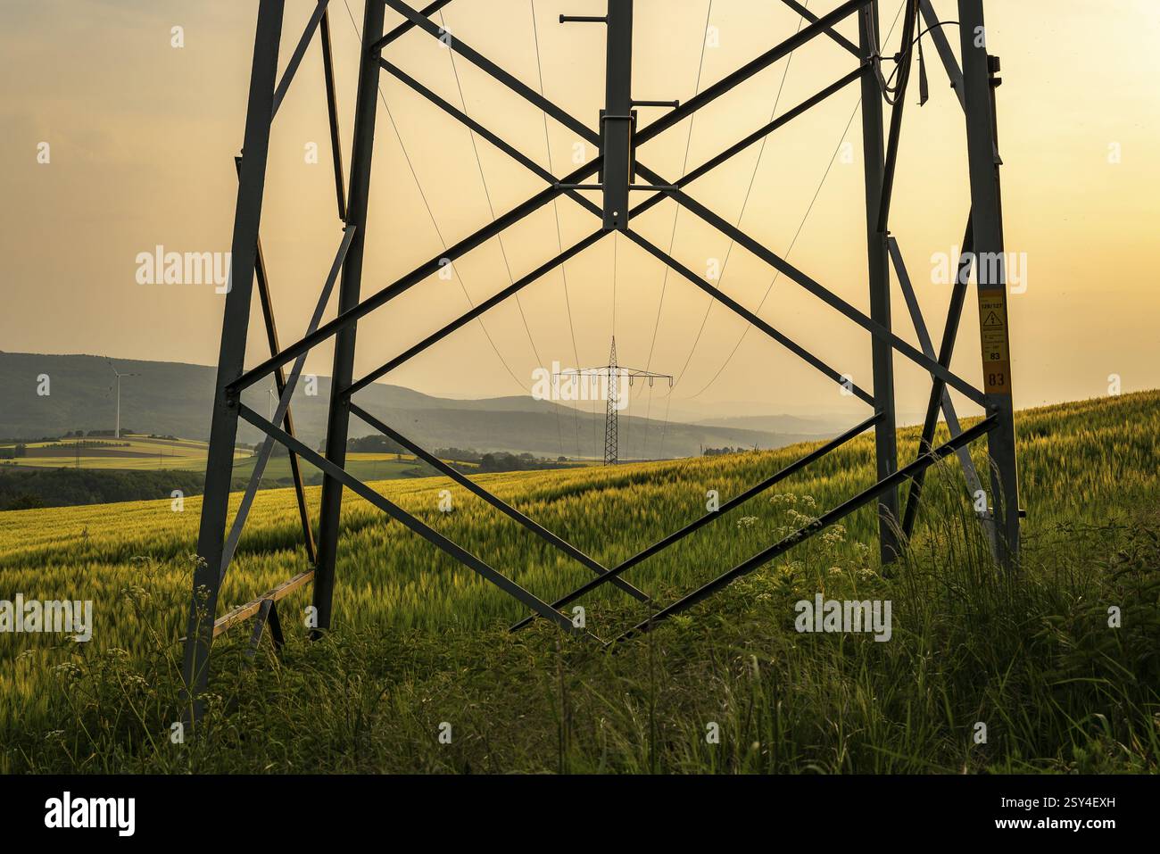 View through the struts of an electricity pylon to another electricity ...