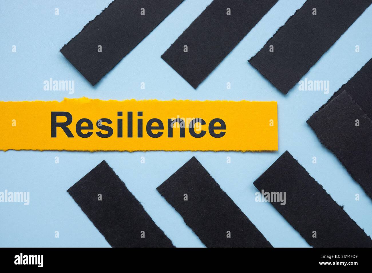 Strips of paper and the word resilience. Mental strength and overcoming ...