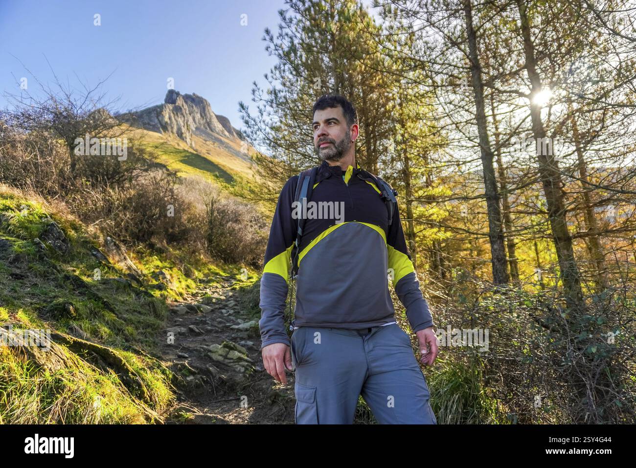 Male backpacker hikes through sunny hi-res stock photography and images ...