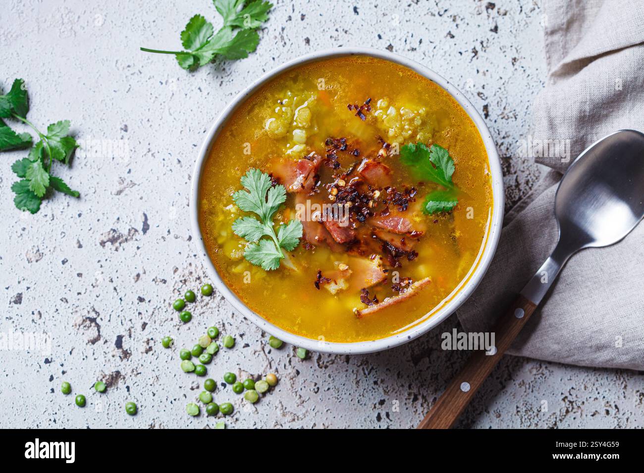 Split pea soup with smoked bacon, top view Stock Photo - Alamy