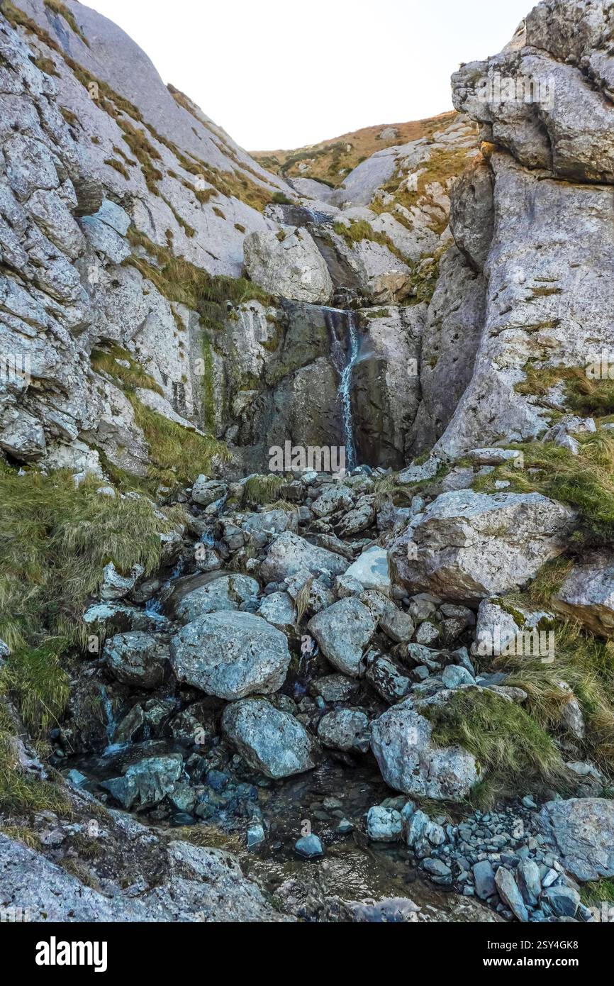 Stunning waterfall cascades down rugged rocks in mount txindoki ...