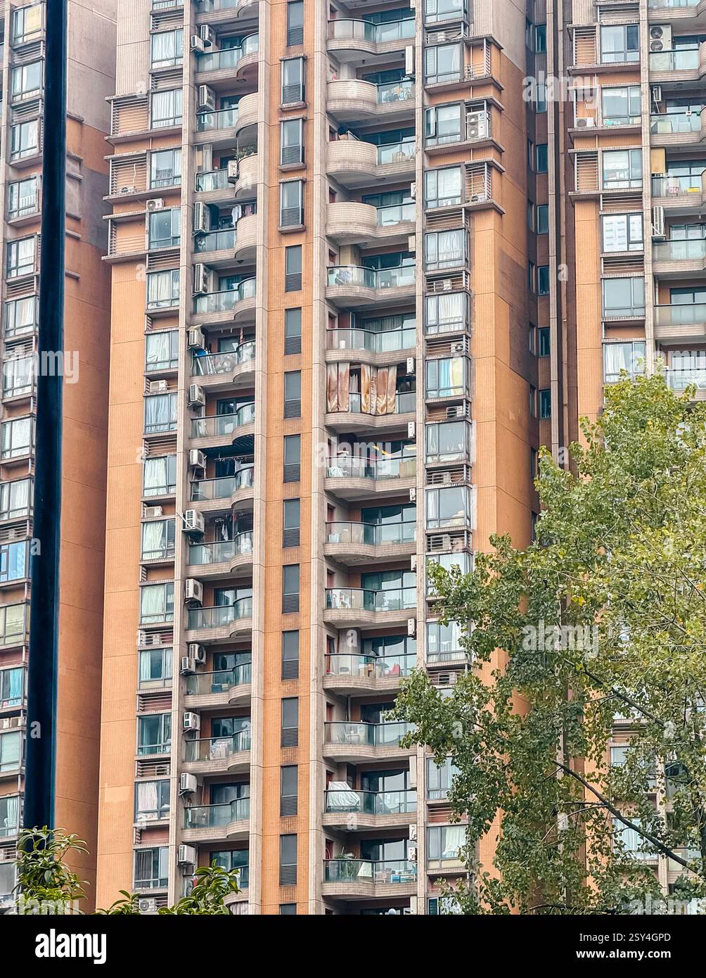 Modern residential building showcasing balconies and air conditioning ...