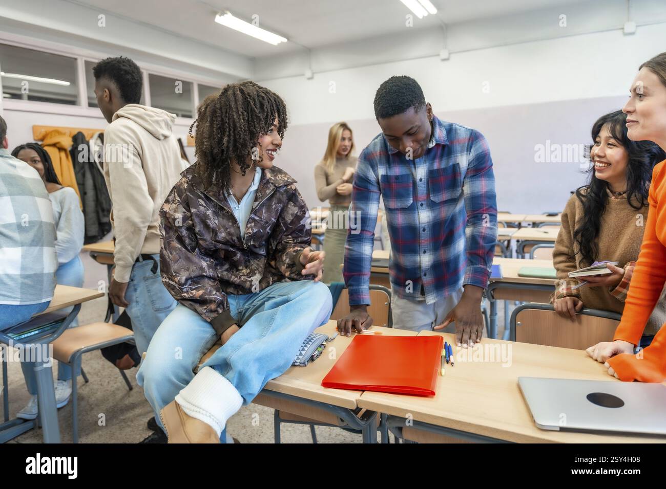 Multi ethnic university students collaborating on a project, discussing ideas and sharing ...