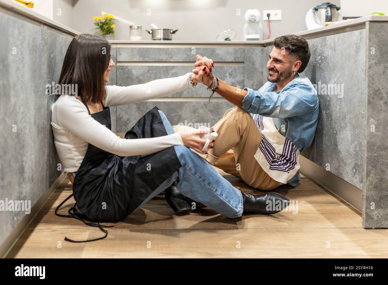 Chefs enjoying a coffee break, holding hands and smiling at each other ...