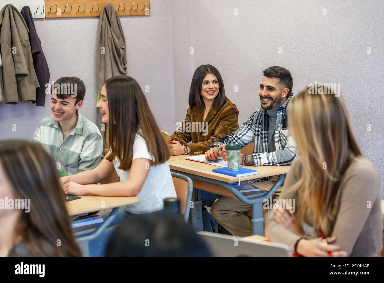 Cheerful university students enjoying their time in the classroom ...