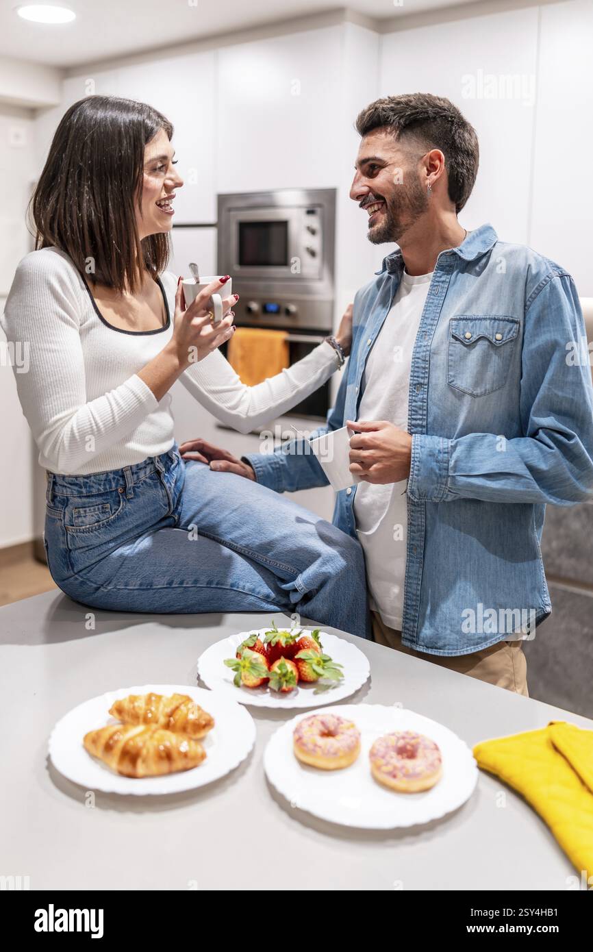 Young friends sharing coffee pastries hi-res stock photography and ...