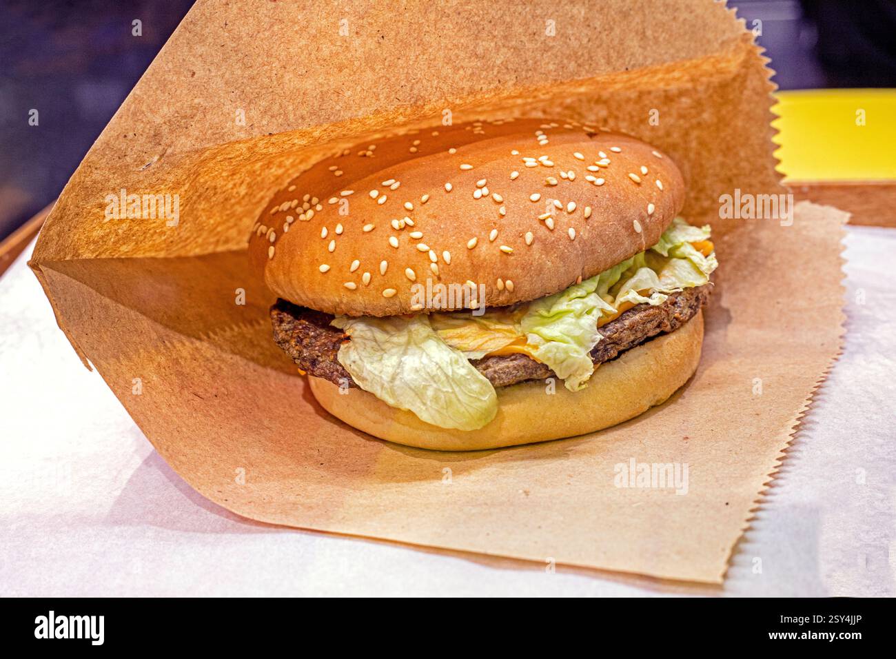 classic burger with salad and beef patty in craft paper at a gas ...
