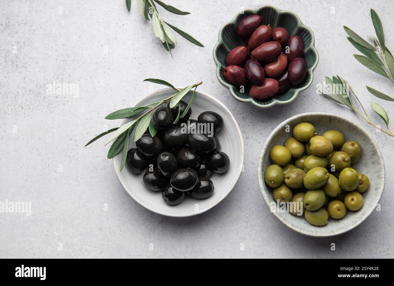 Variety of olives with olive tree branches, creating a mediterranean ...
