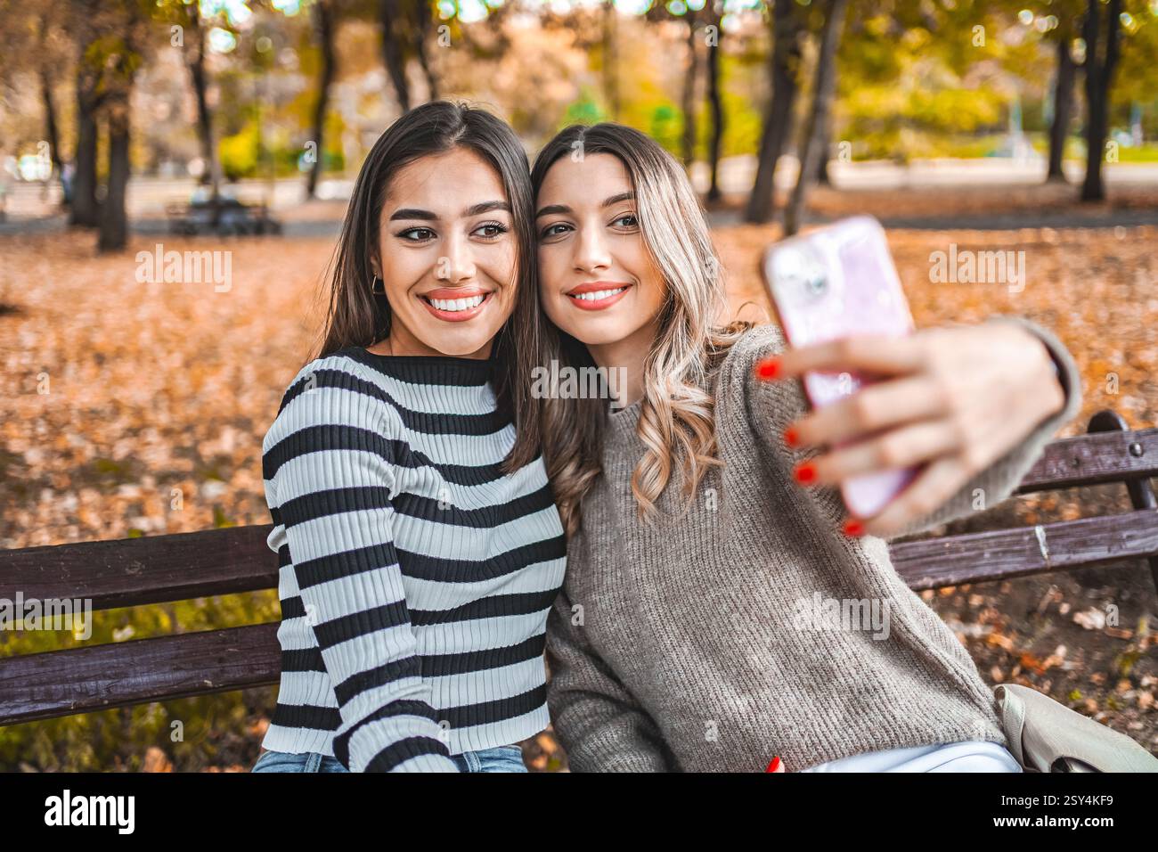 Two Women Taking a Picture With Their Cell Phone Stock Photo - Alamy