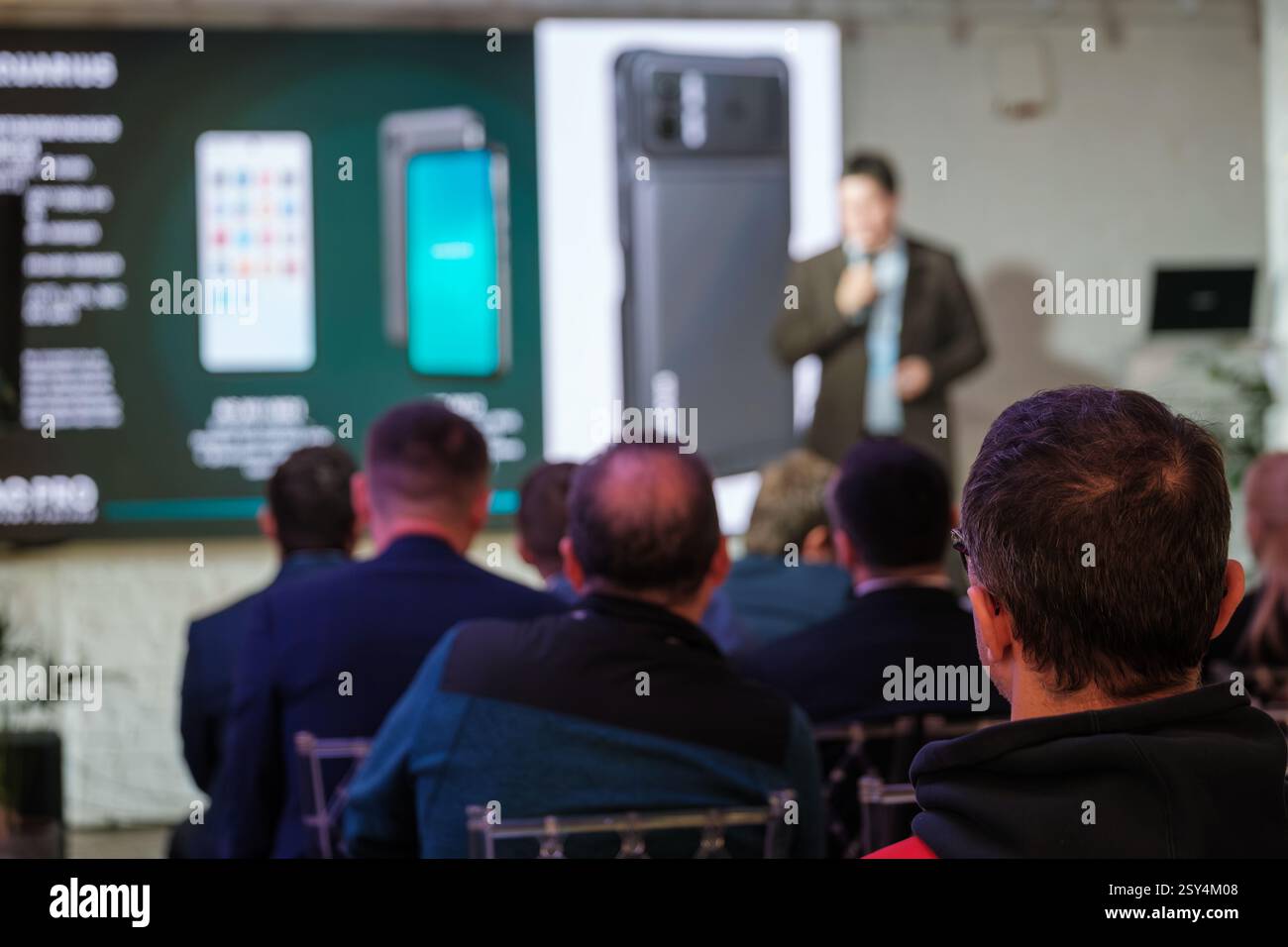 Audience listening to speaker during business presentation featuring ...