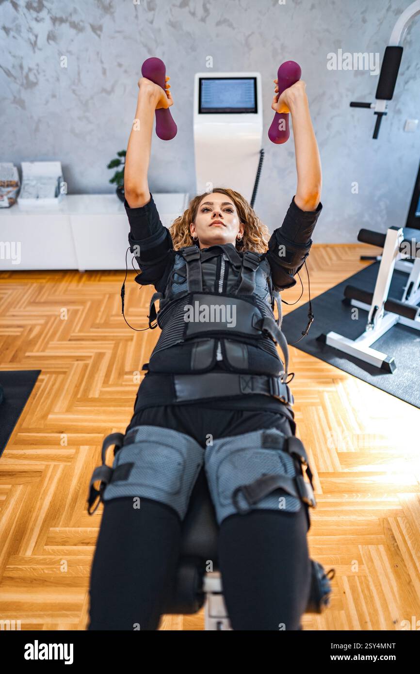 Empowered strength training session with muscle stimulation Stock Photo ...