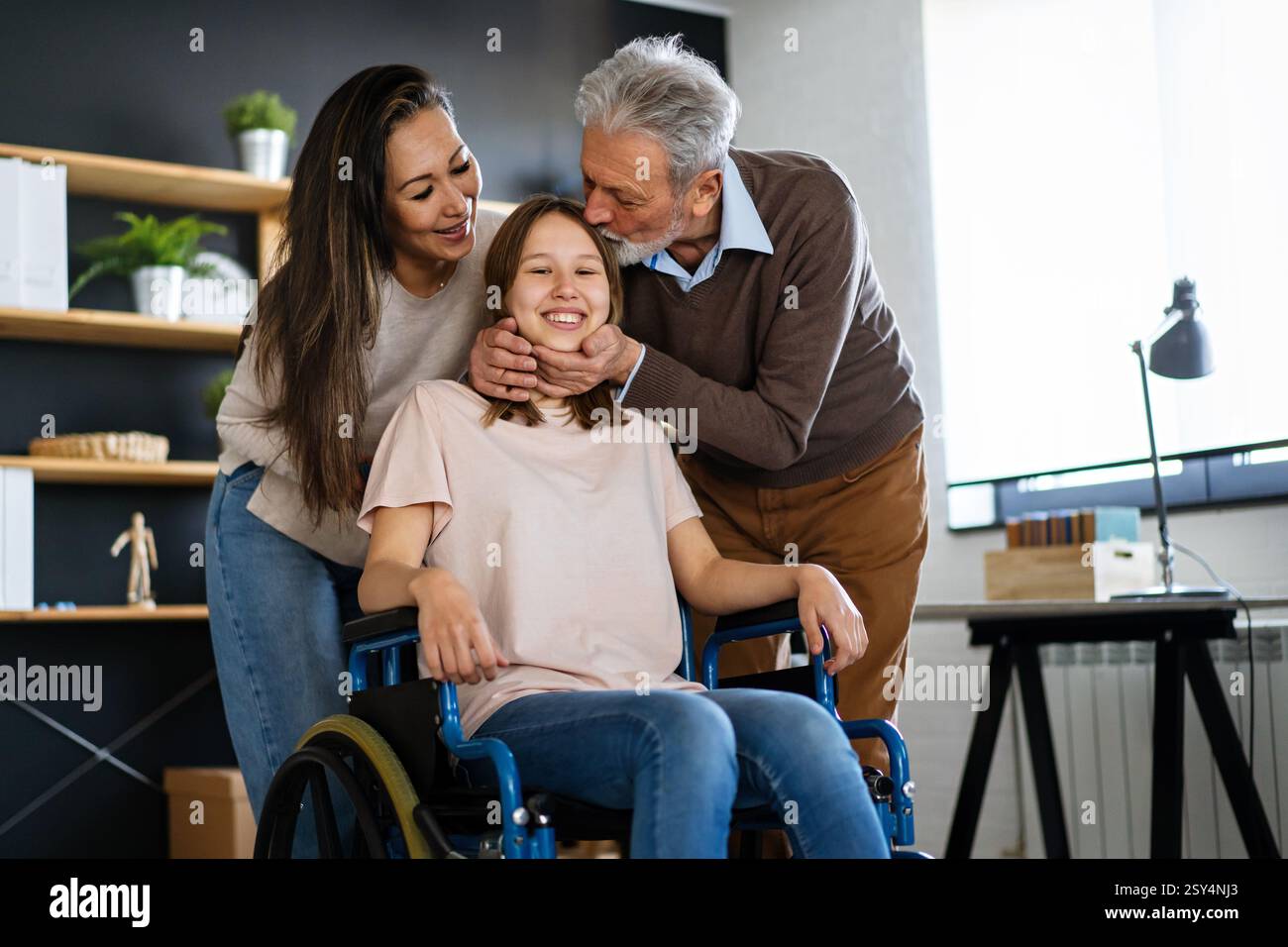 Happy multiethnic family with child with disability in wheelchair Stock ...