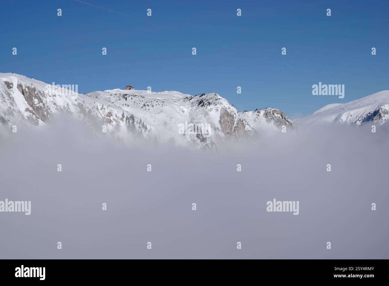 Winter inversion weather - panorama of snow covered mountain Schneealpe ...