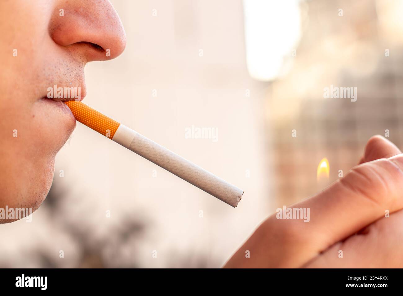Smoking concept. Man lighting a cigarette with a lighter. Smoking a ...