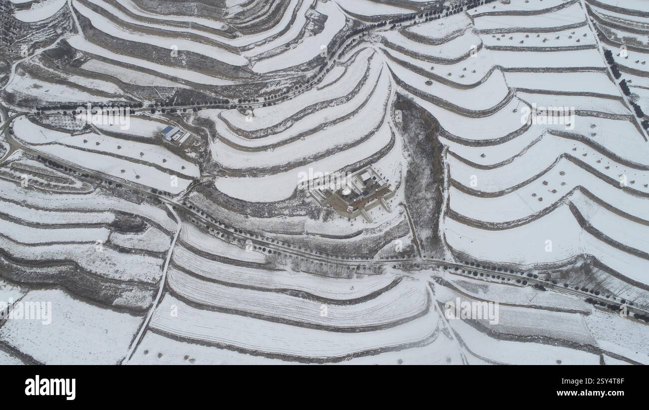 Aerial photo shows the snow-covered terraced fields in Dingxi City ...