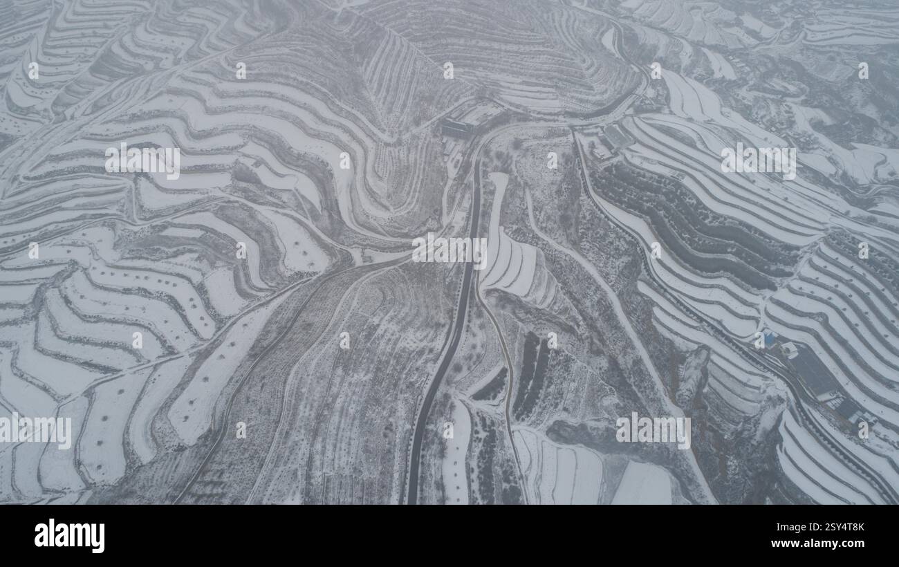 Aerial photo shows the snow-covered terraced fields in Dingxi City ...