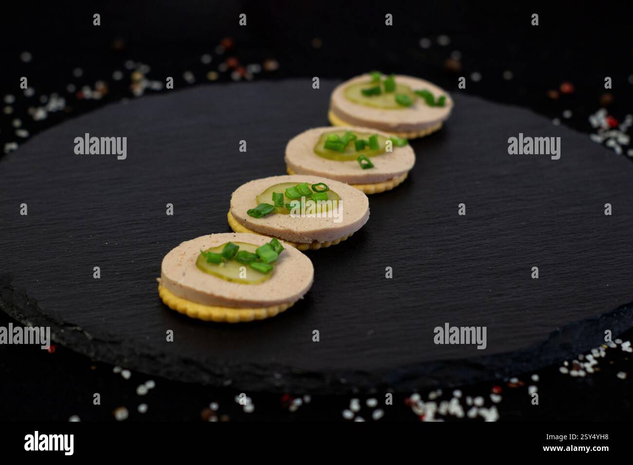 canapes with pate and greens on black plate front view Stock Photo - Alamy