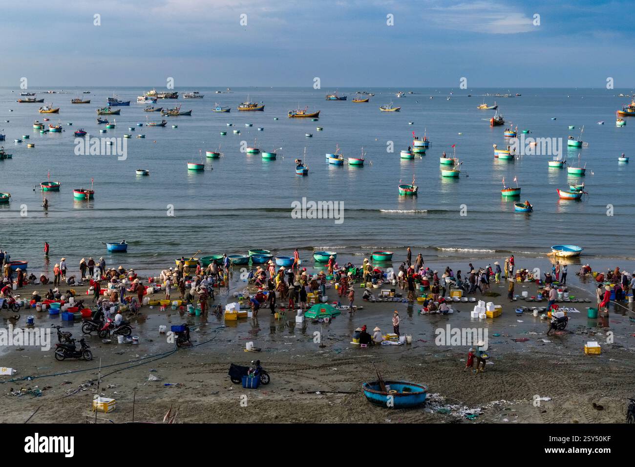 Aerial view of people working on the beach of Mui Ne, Mũi Né, many ...