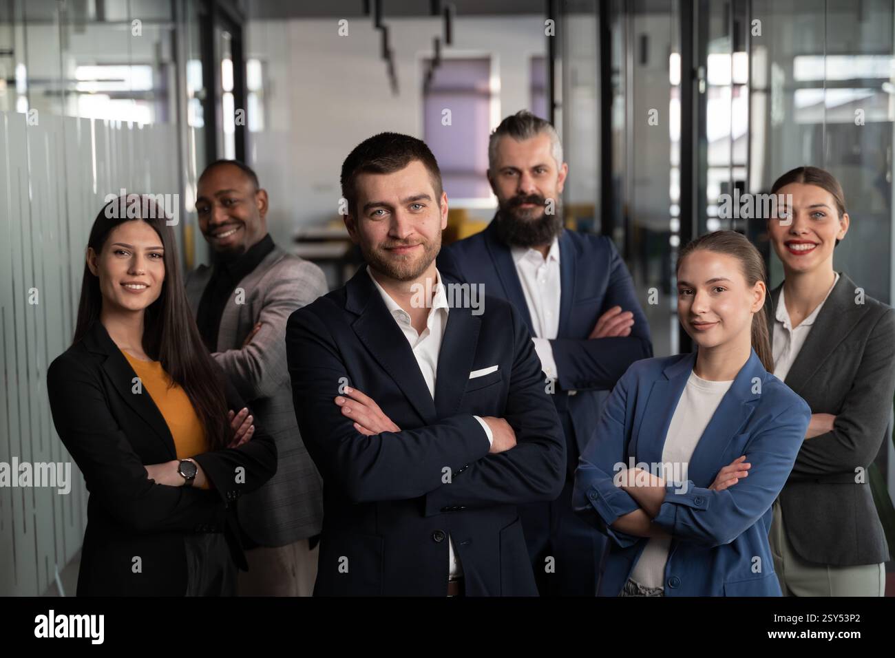 Confident business team standing together in a modern office, dressed ...