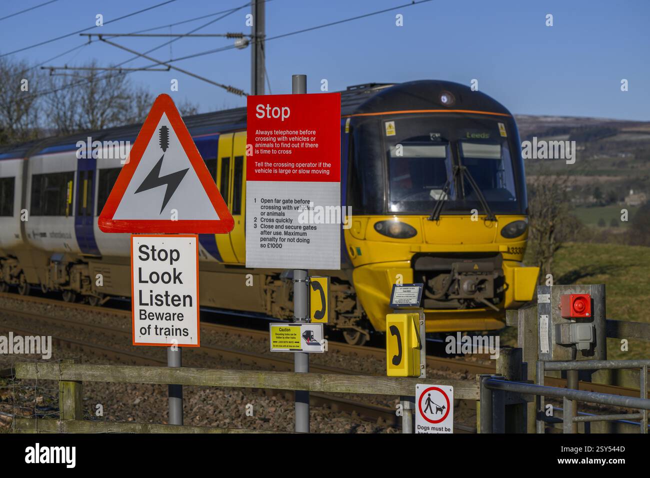 Northern Rail train traveling across unmanned level crossing (trackside ...