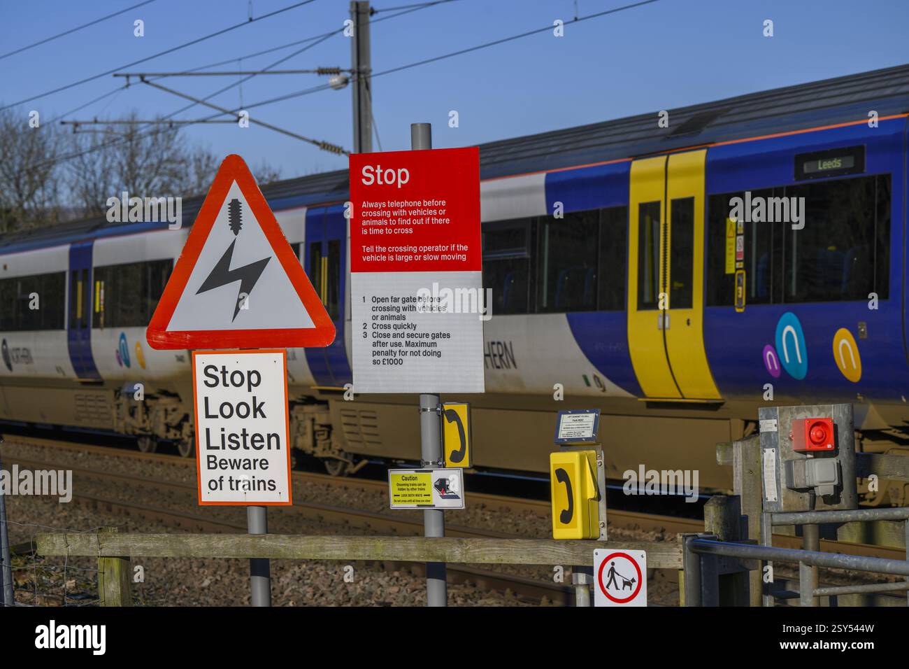 Northern Rail train traveling across unmanned level crossing (trackside ...