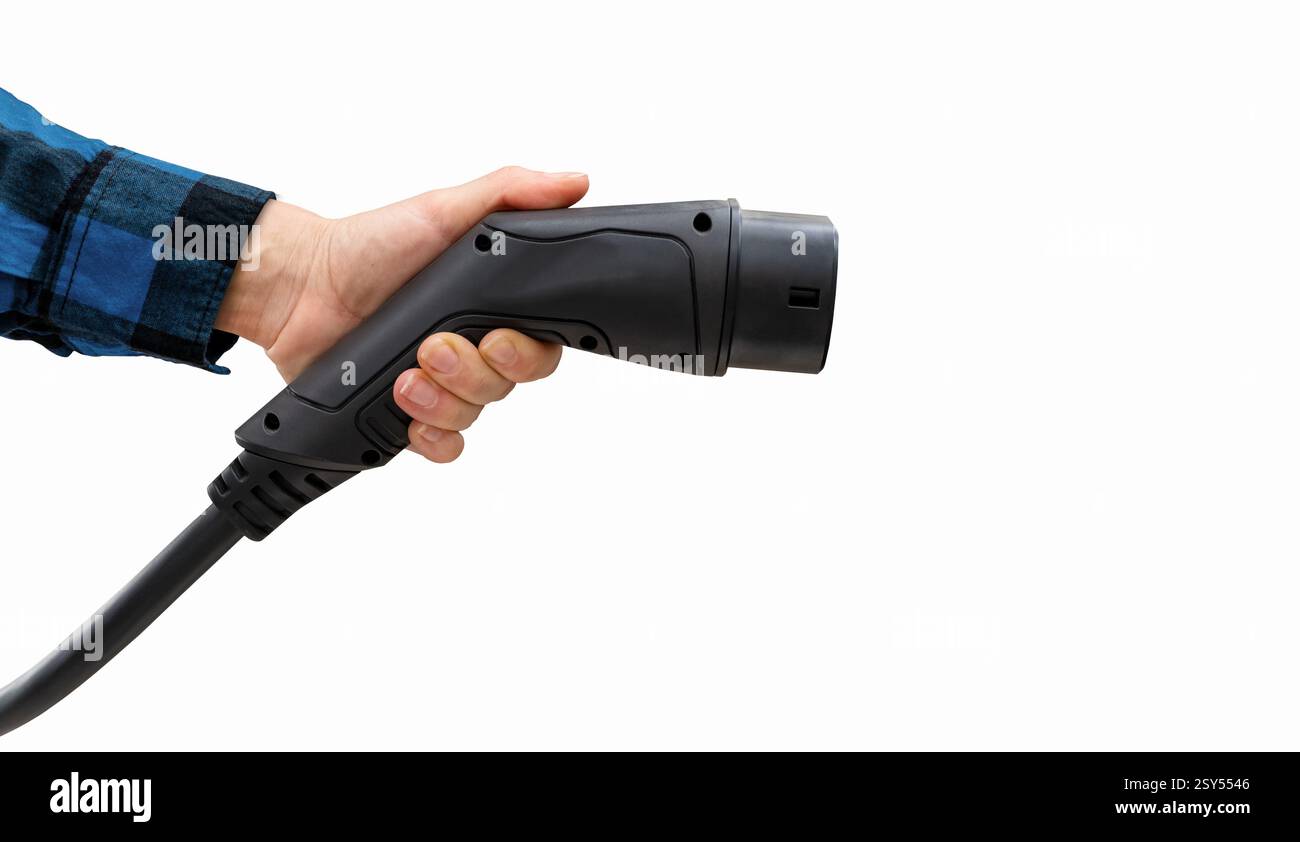 Isolated black EV charging plug in female hand in blue sleeve. Electric ...