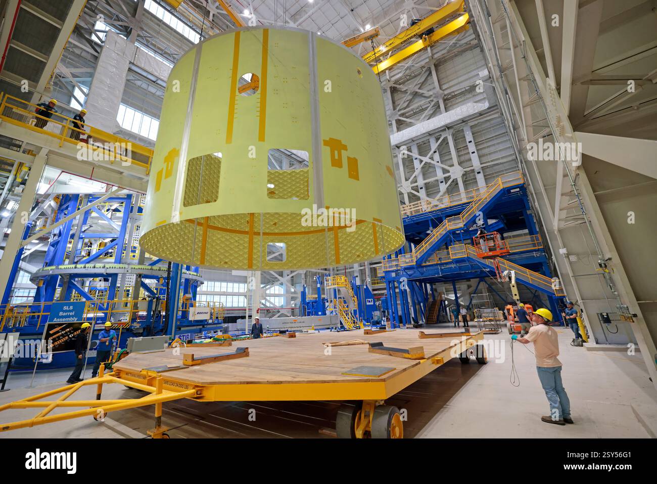 Technicians at NASA’s Michoud Assembly Facility move the engine section ...