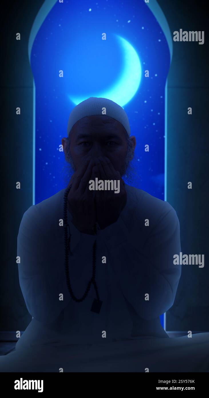 A religious Muslim man with prayer beads raising his hand and praying ...