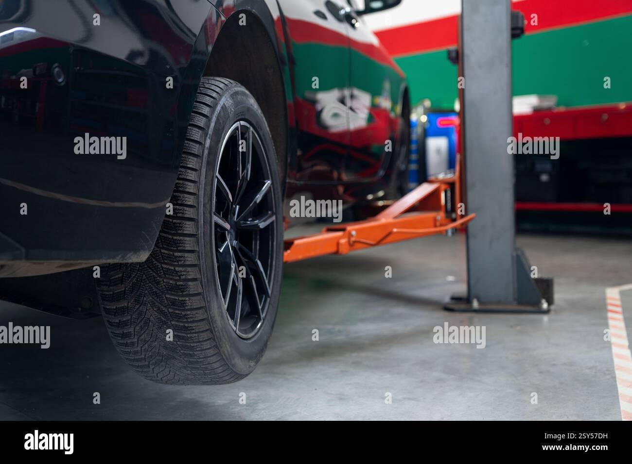 Car service workshop with cars on a column lifts Stock Photo - Alamy
