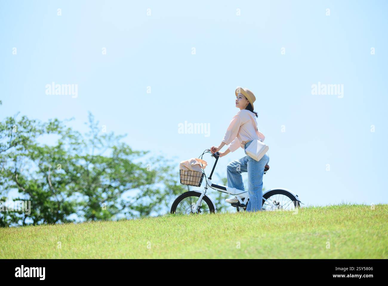 Japanese Woman Riding A Bicycle On A Hill Stock Photo - Alamy