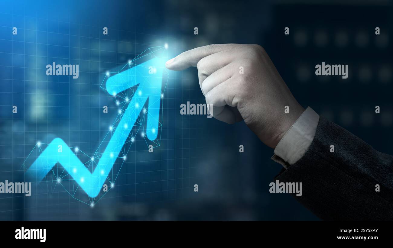 Businessman pointing a holographic upward arrow of the economic chart ...