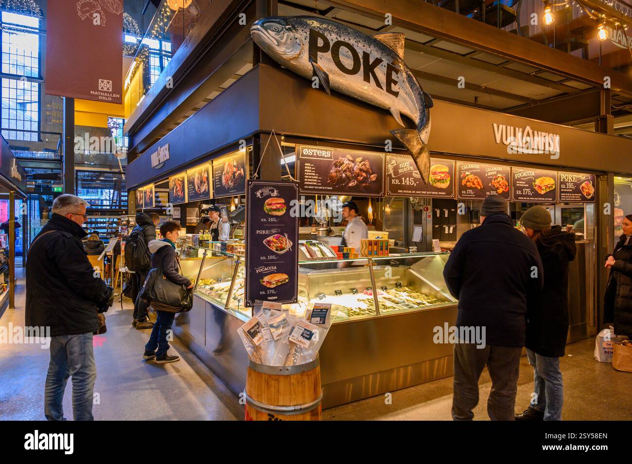 Inside Mathallen Oslo, an old industrial building converted to a food market with small ...