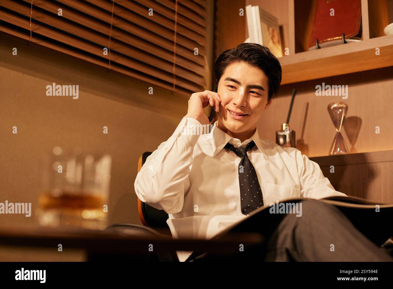 Japanese Man Sitting On A Chair Stock Photo - Alamy