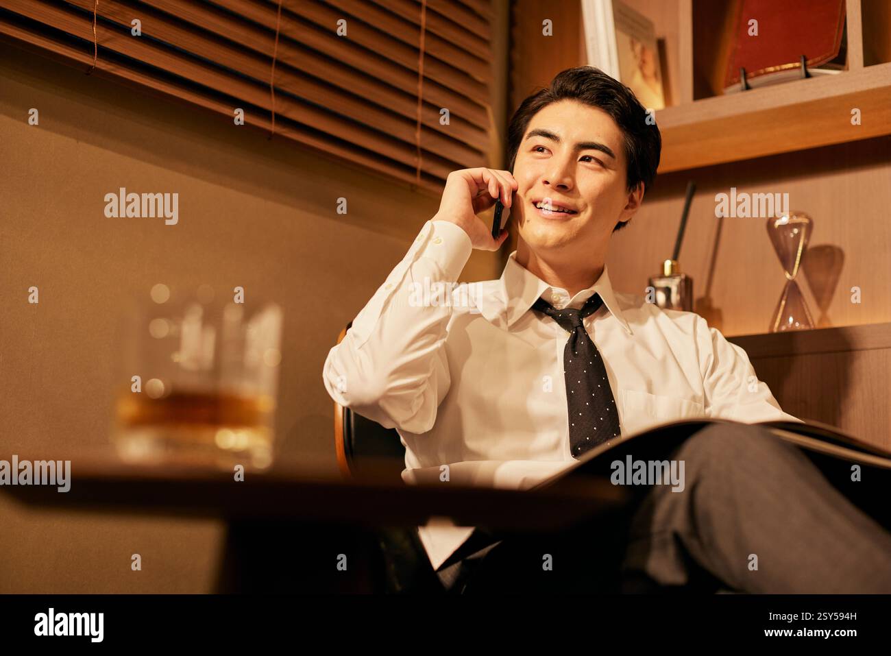 Japanese Man Sitting On A Chair Stock Photo - Alamy