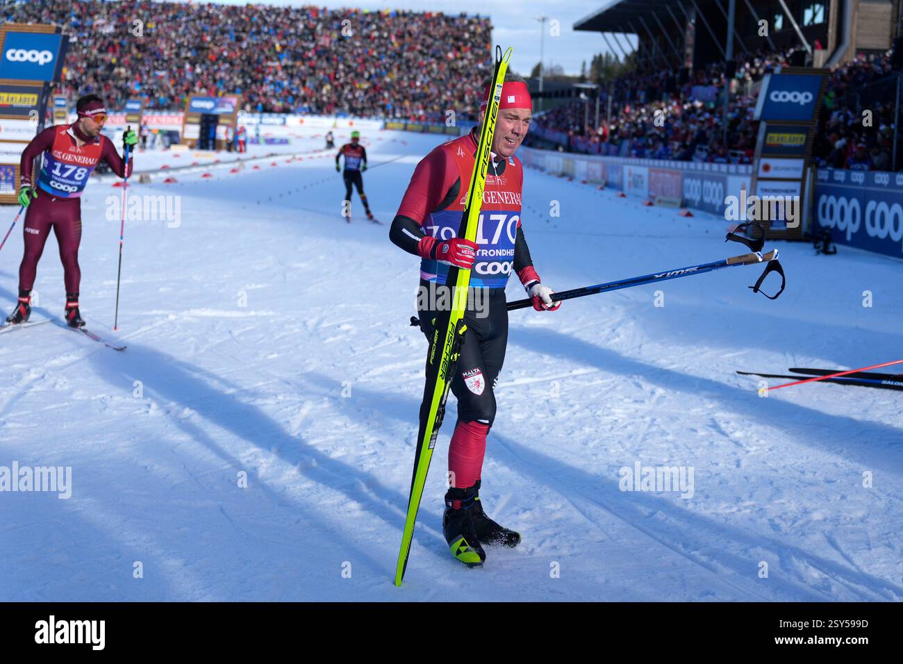 Frederick Arthur Crosetto of Malta rests after he crossed the finish ...