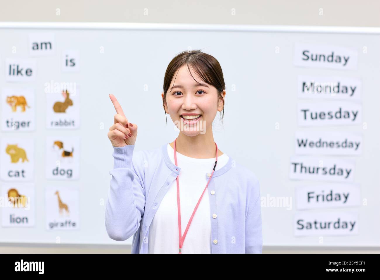 Japanese Woman Pointing To A Whiteboard With Words On It Stock Photo ...