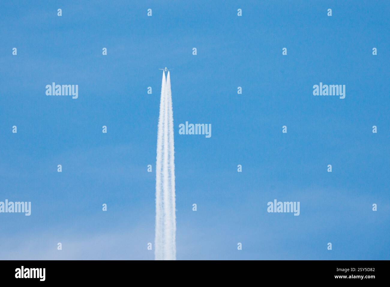 aircraft with a wide contrail in the blue sky, Germany, Bavaria Stock ...