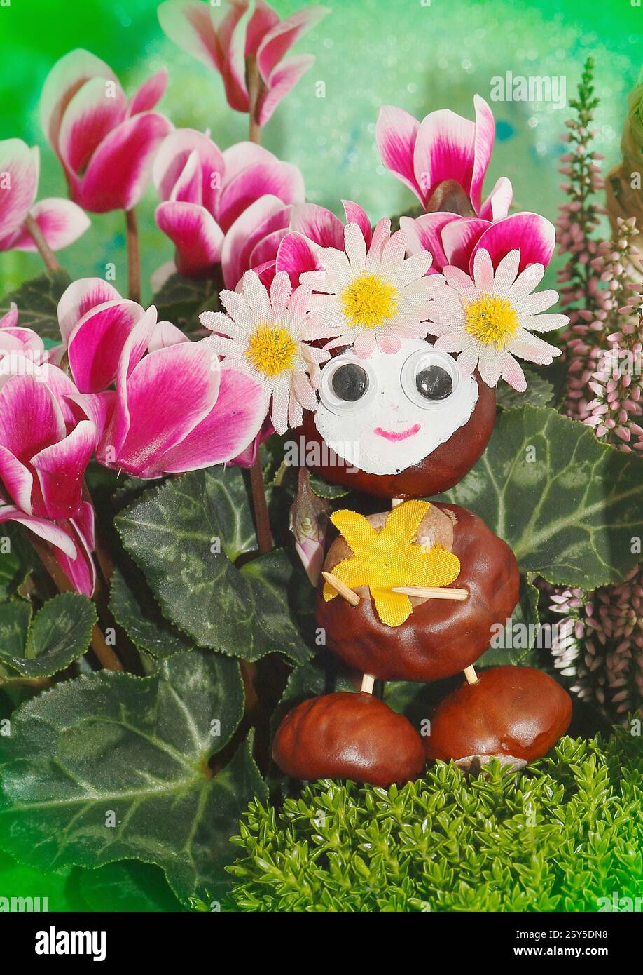 funny chestnut figure standing in a flower basket planted with a ...