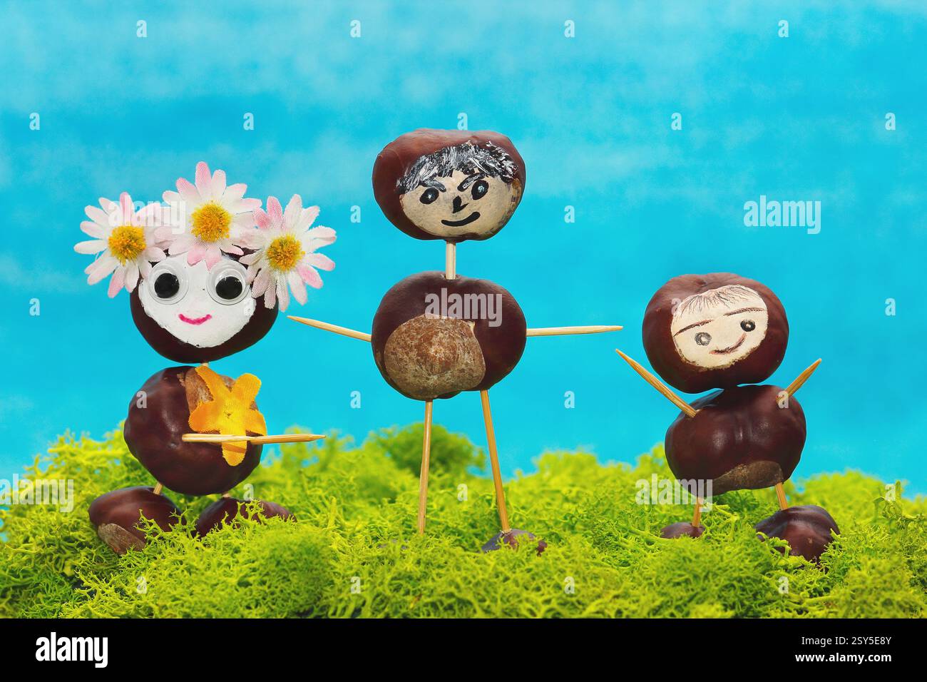 funny chestnut figure family standing on moss Stock Photo - Alamy