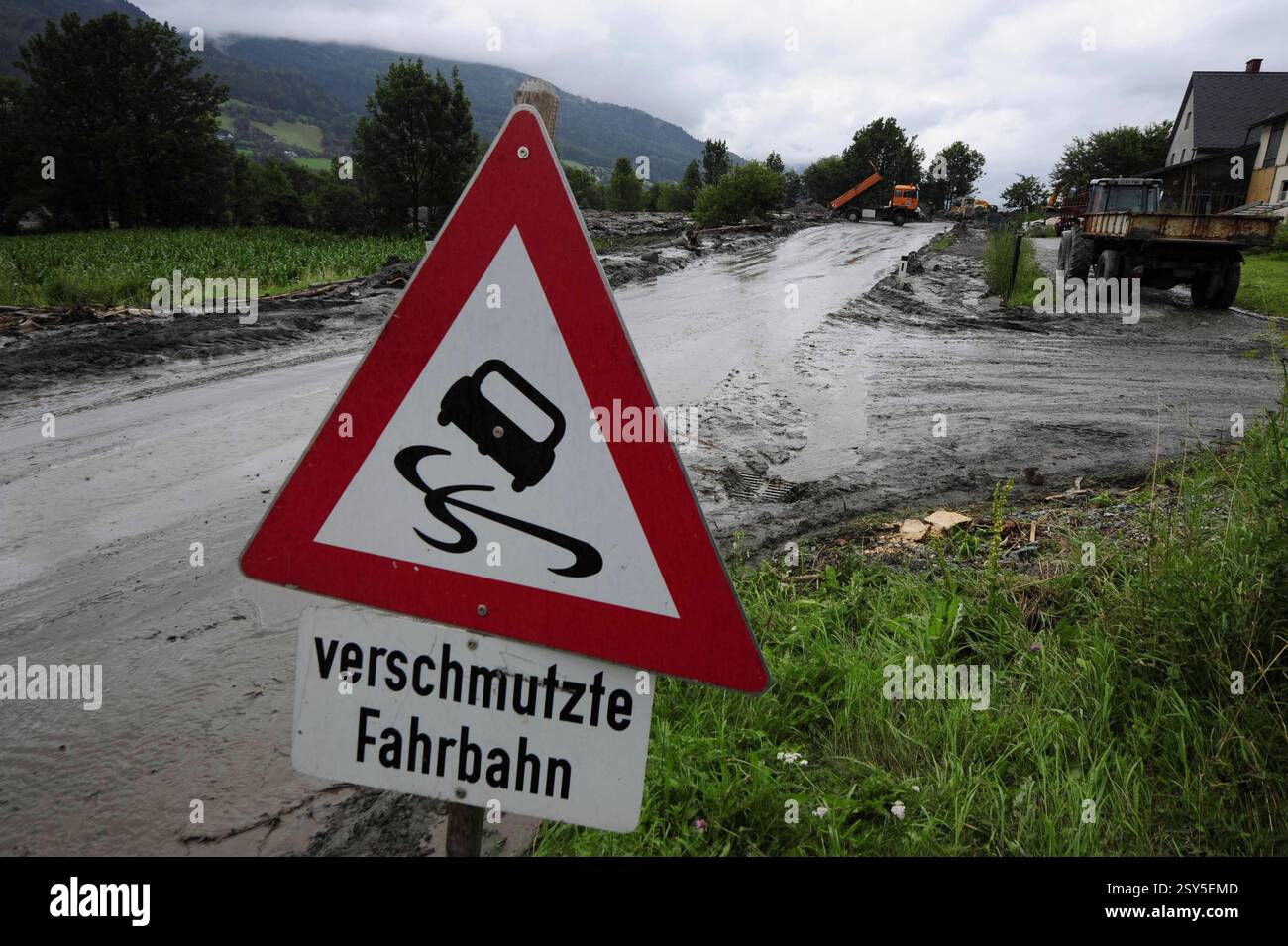 an attention slippery road ahead warning sign in road traffic attention ...